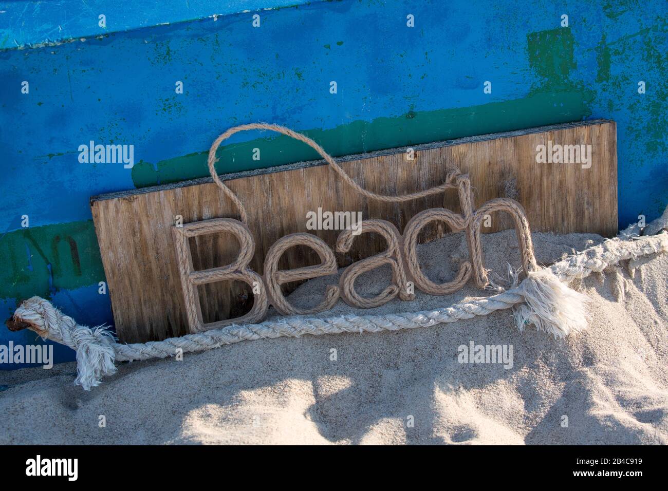 Beach sign made of rope leaning on a blue boat Stock Photo - Alamy