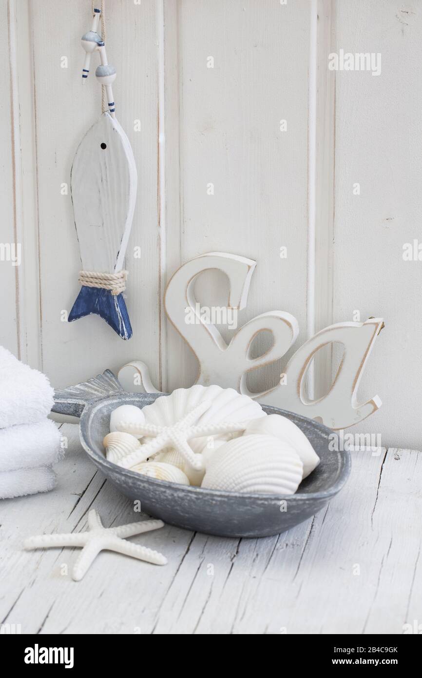 maritime still life on white wood with decorative wooden fish and word ...