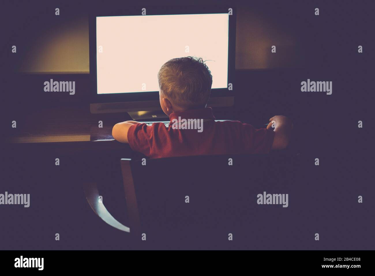 Boy watching at monitor hi-res stock photography and images - Alamy