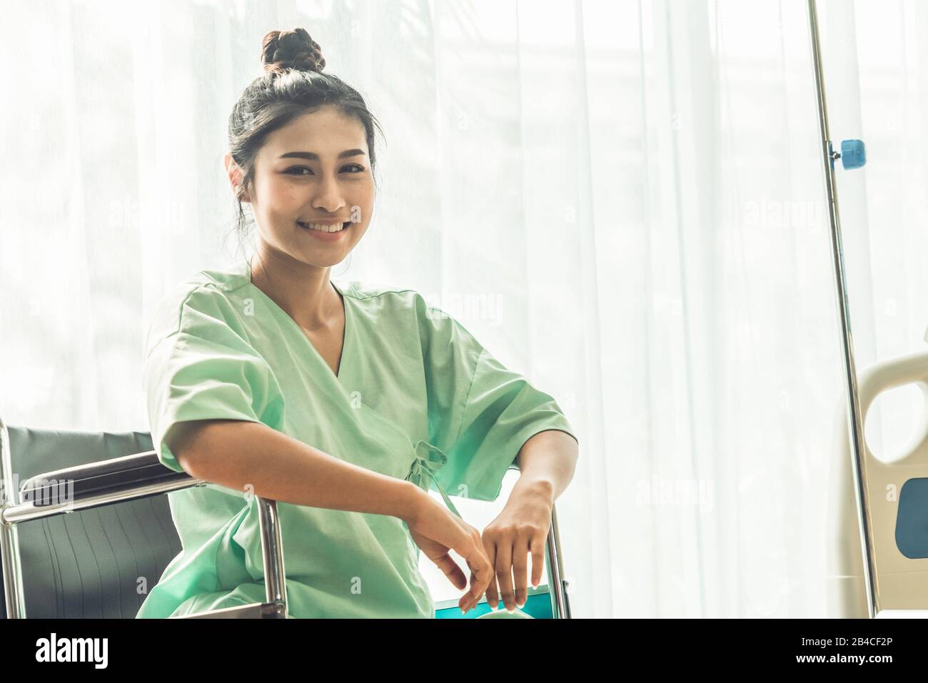 Happy patient smile while sitting on wheelchair after recovery from ...