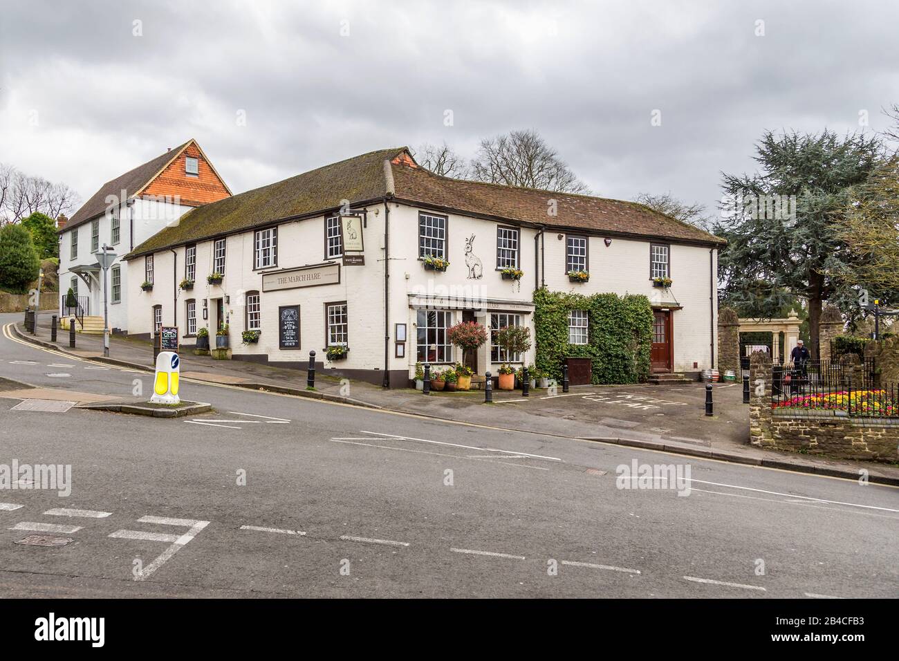 A quaint whitewashed English pub and restaurant named The March Hare ...