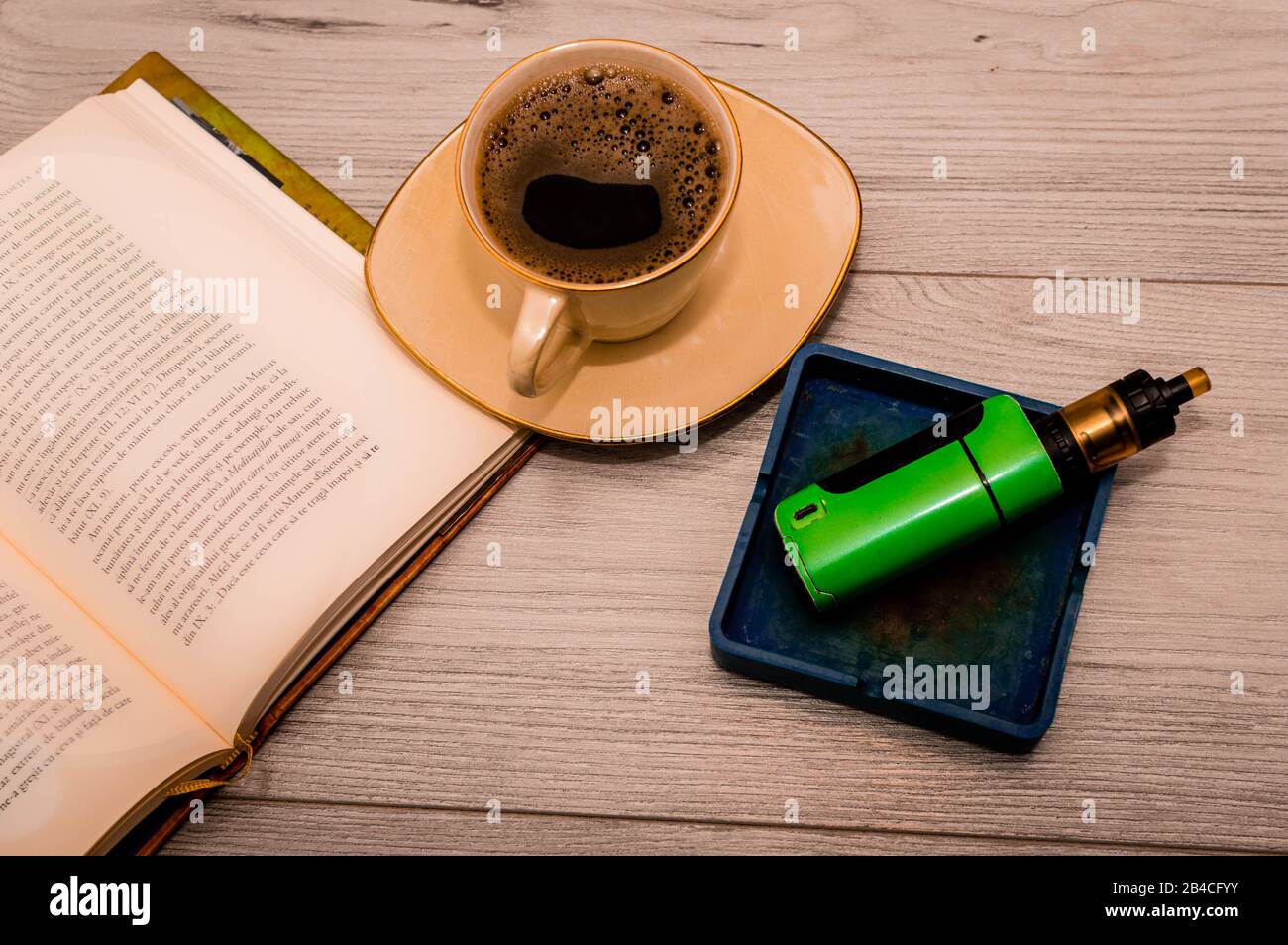 Vape next to a cup of coffee Stock Photo - Alamy