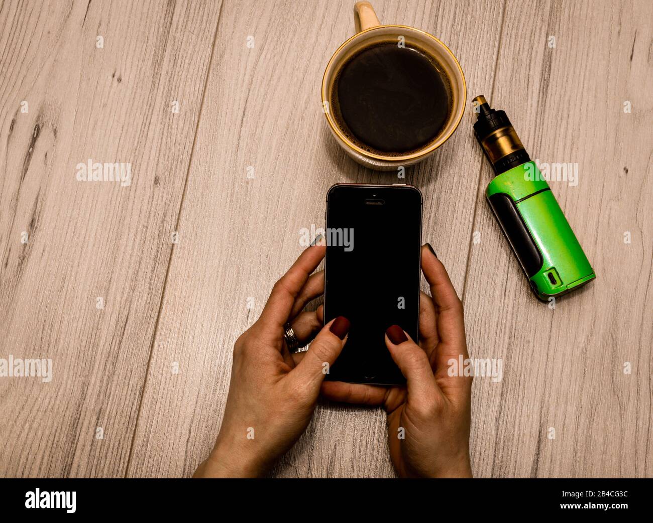 Vape next to a cup of coffee Stock Photo - Alamy