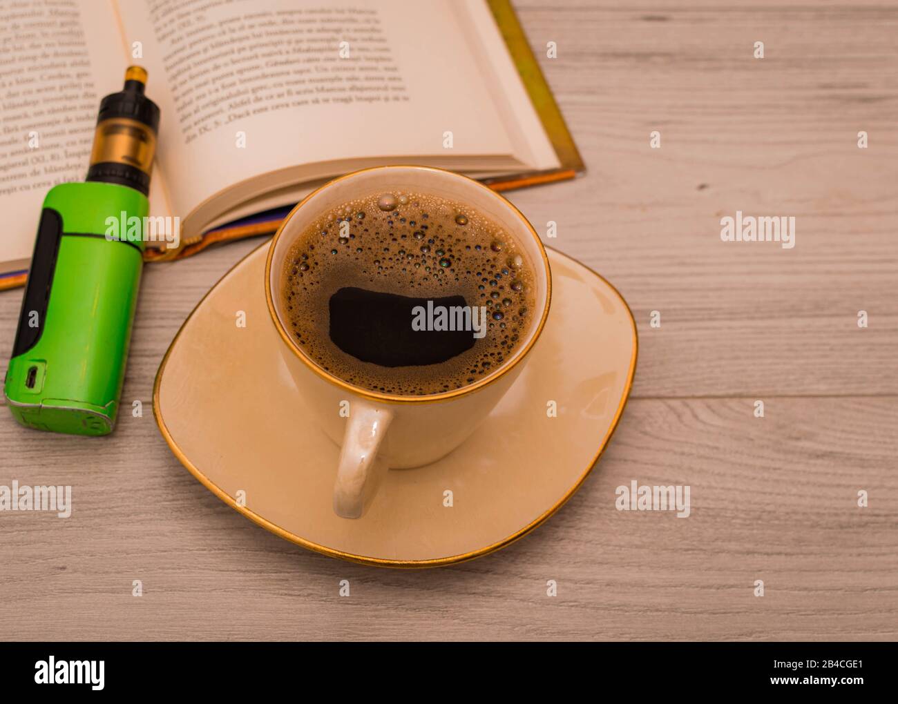 Vape next to a cup of coffee Stock Photo - Alamy