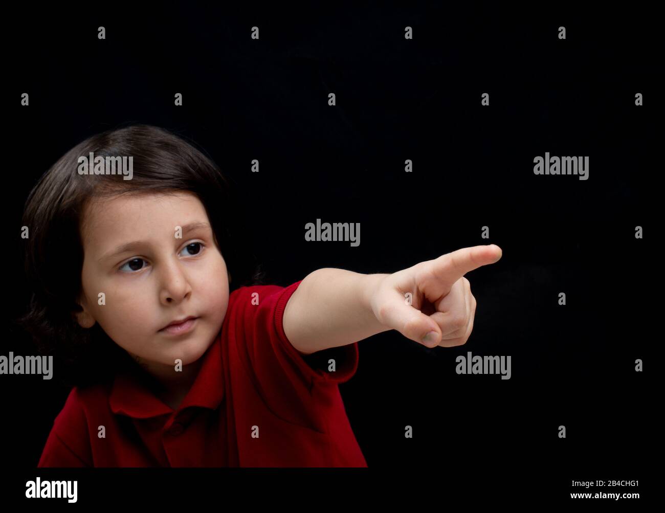 Happy smiling kid boy pointing his finger away Stock Photo - Alamy