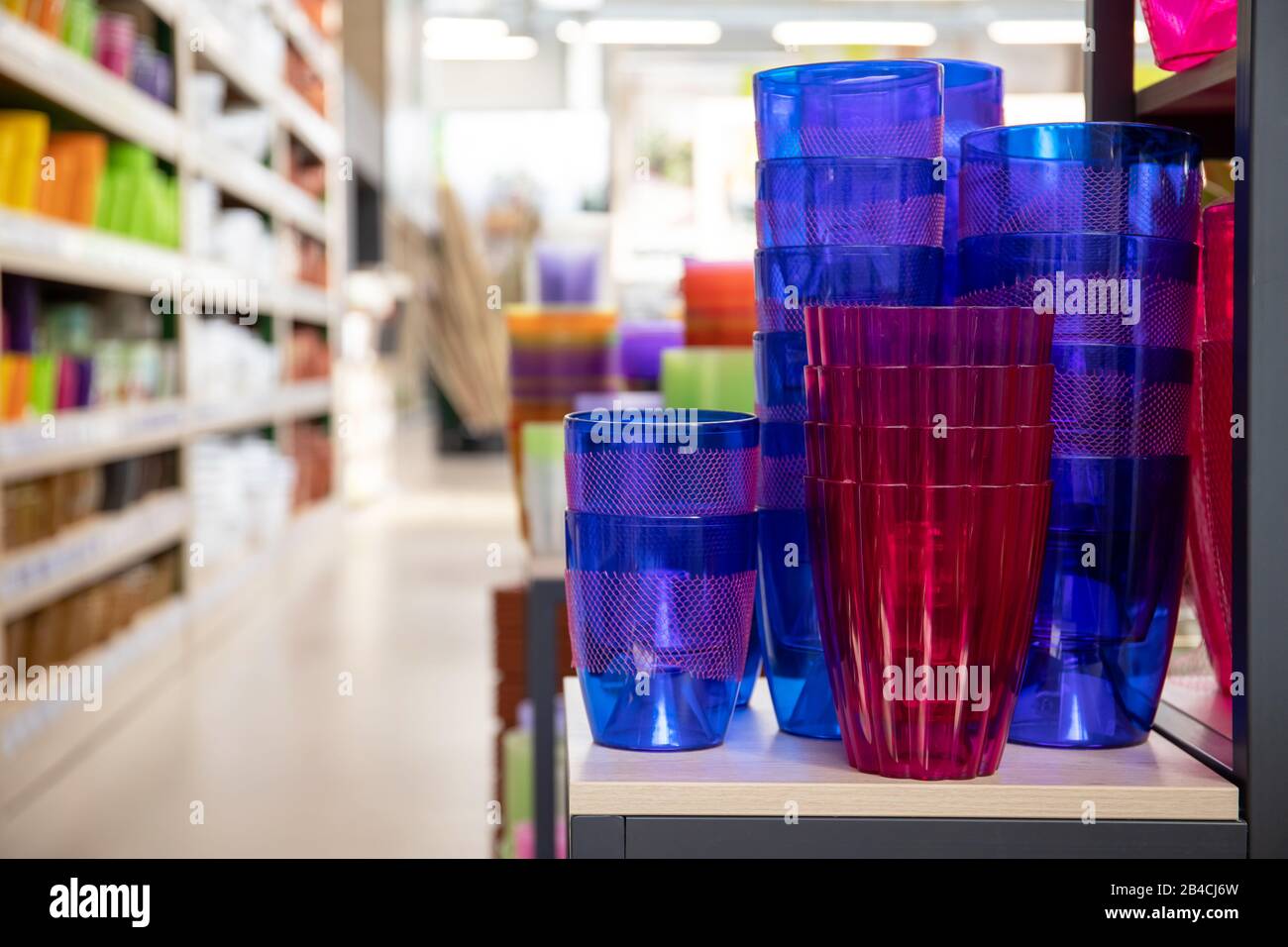 Flower shop interior. Bright multi-colored plastic pots on a shelf ...
