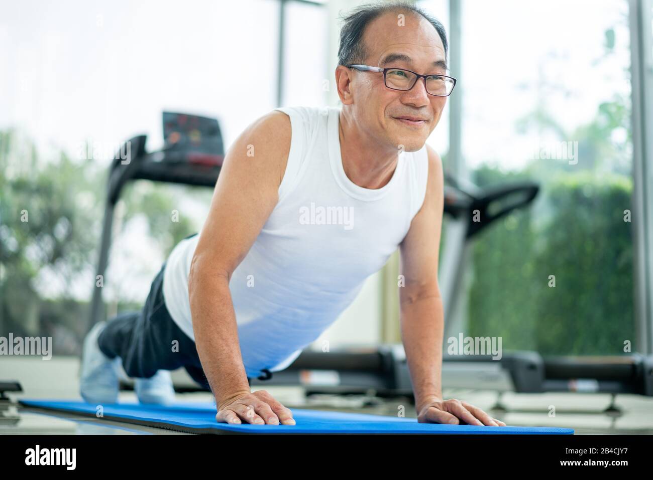Senior man push up in fitness gym. Mature healthy lifestyle Stock Photo ...