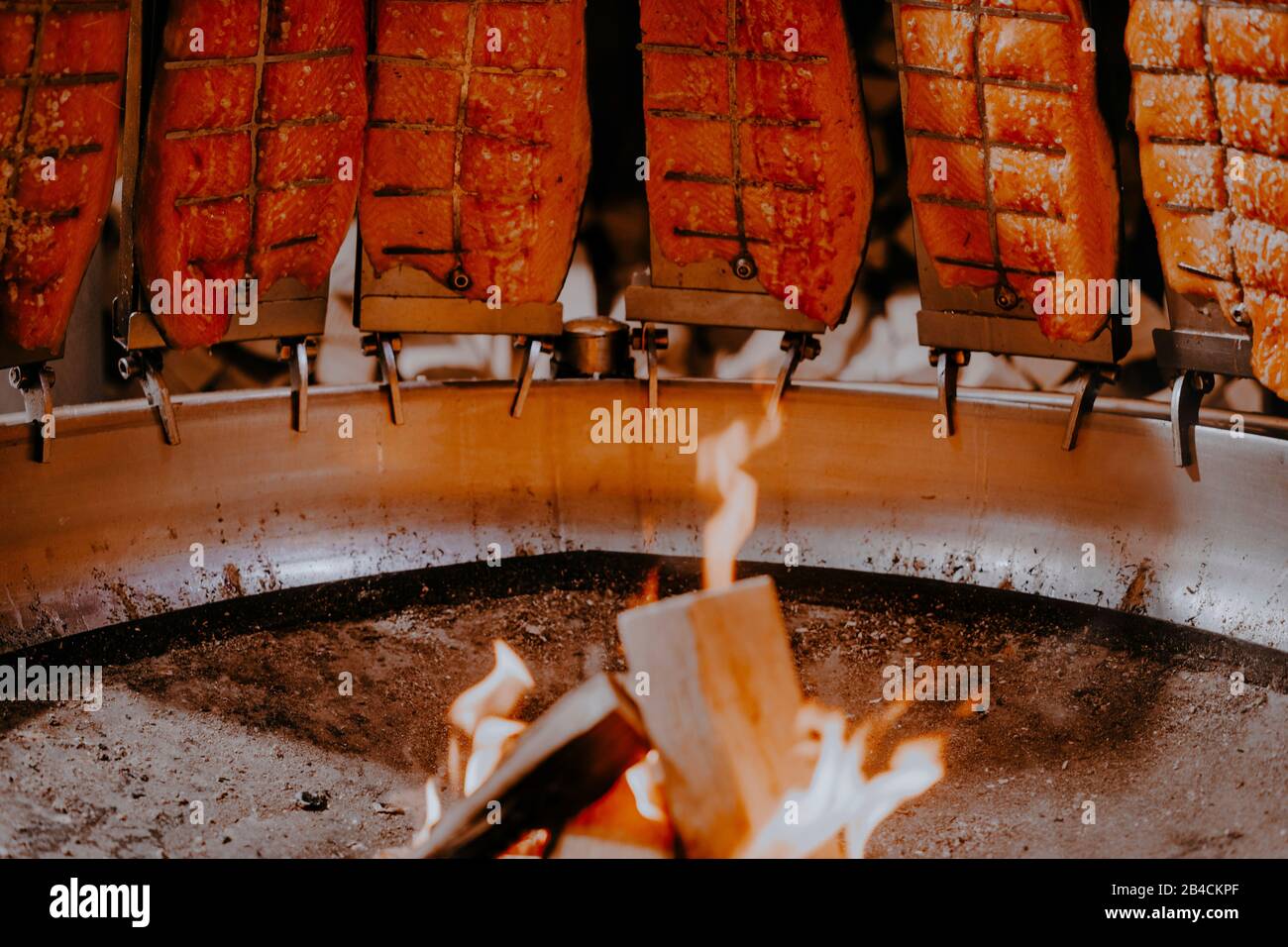 Salmon fish smoked on open fire at Christmas market in Hamburg, Germany ...