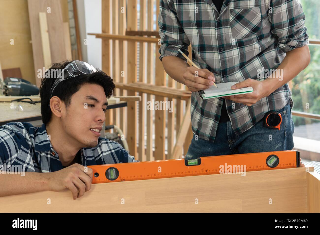 Carpenter working on wood craft at workshop to produce construction ...