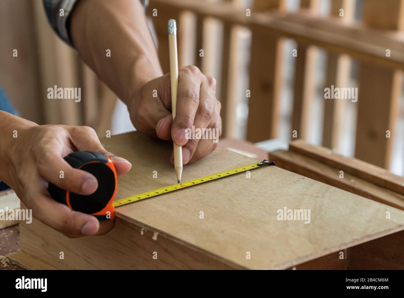 Carpenter working on wood craft at workshop to produce construction ...
