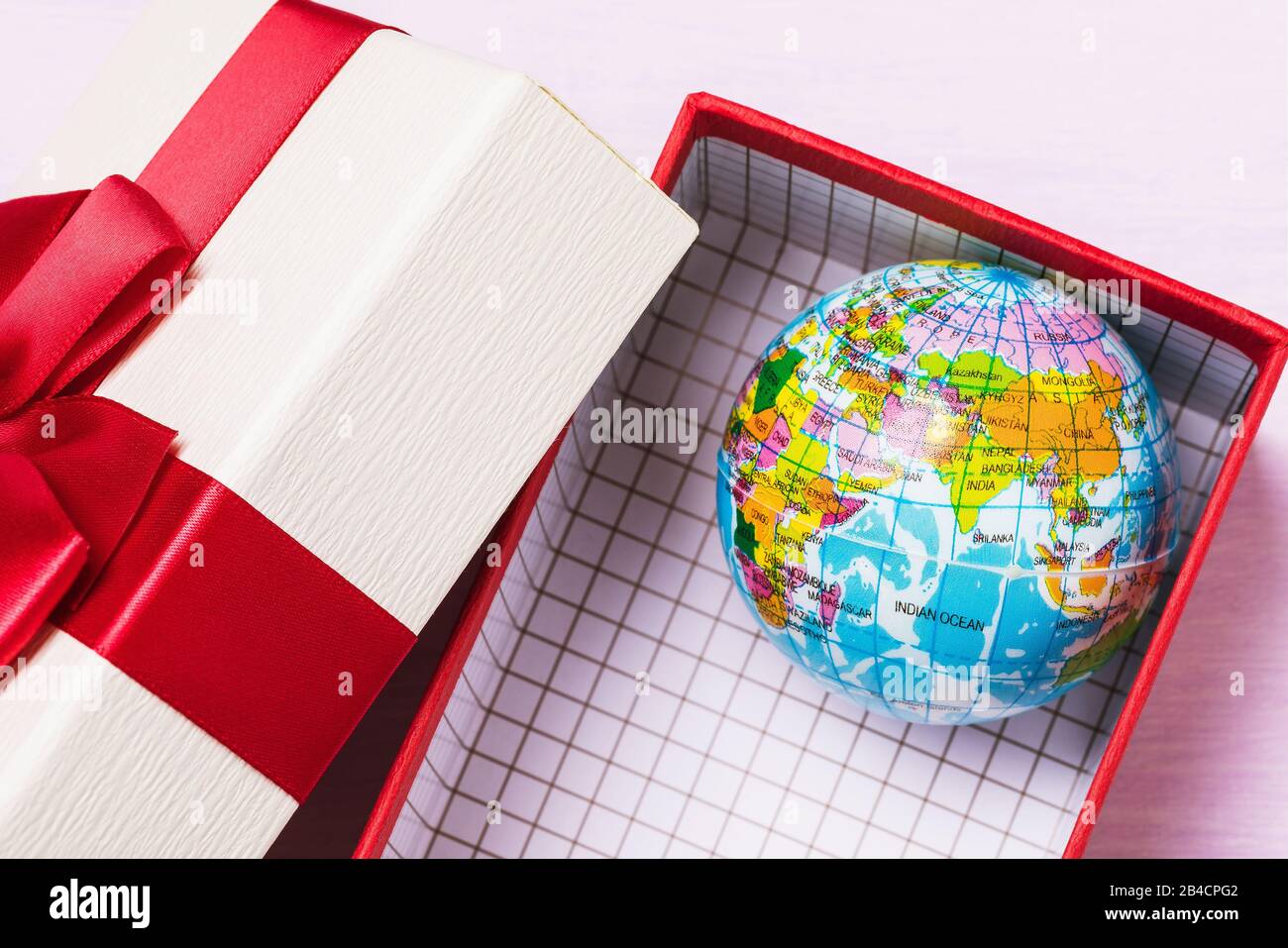 Toy globe in a gift box, close-up Stock Photo - Alamy