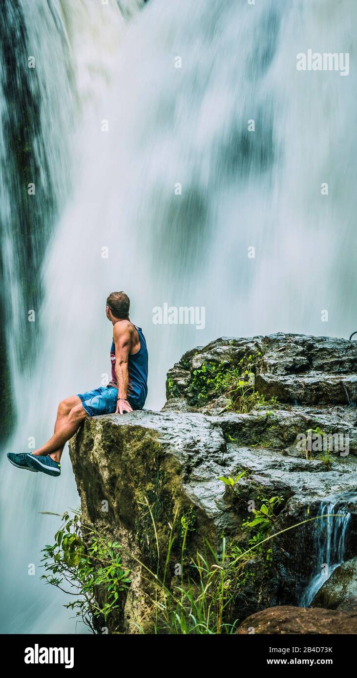 Man sitting near waterfall hi-res stock photography and images - Alamy