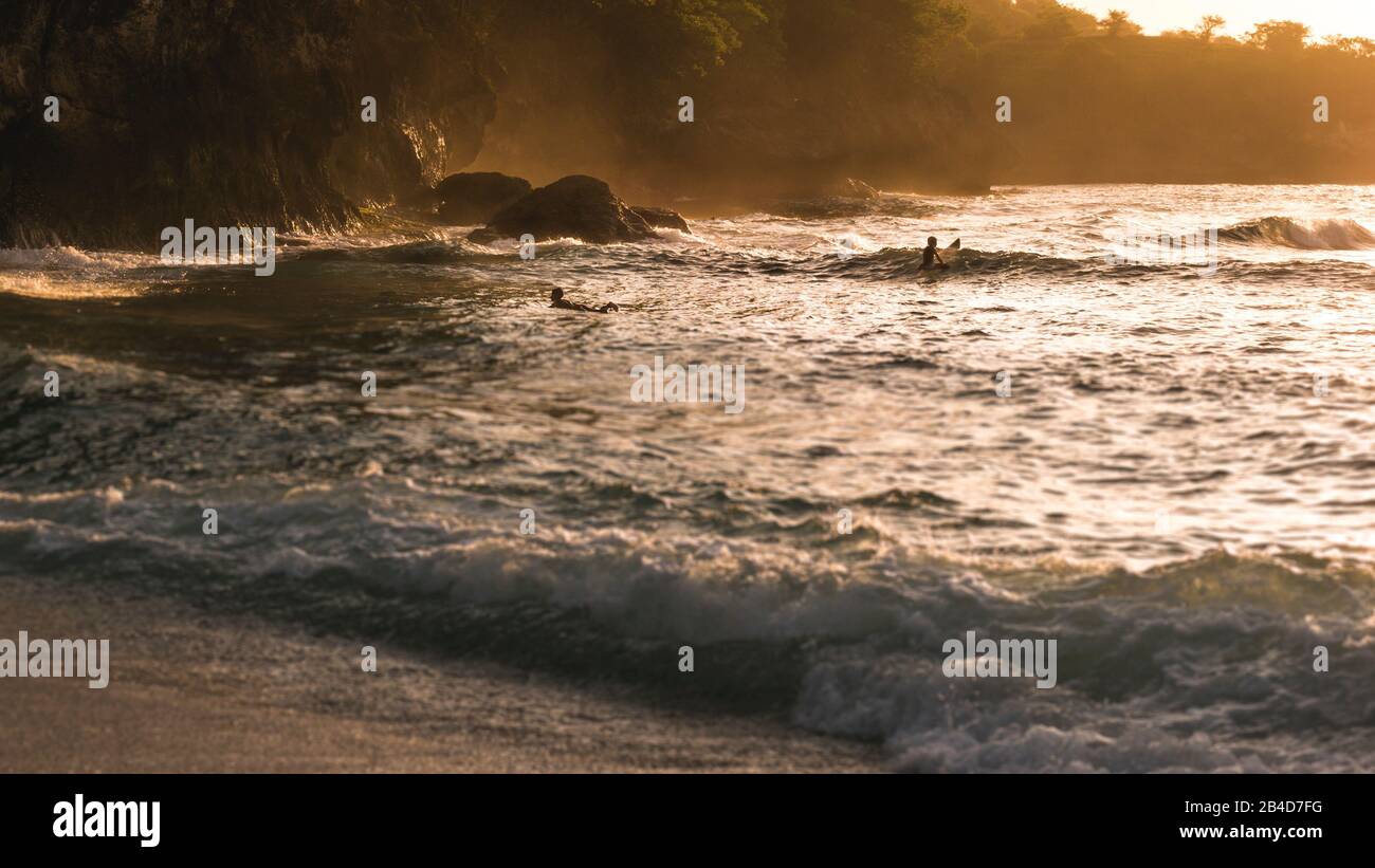 Local Kids surf on Waves in Sunset light, Beautiful Crystal Bay, Nusa ...