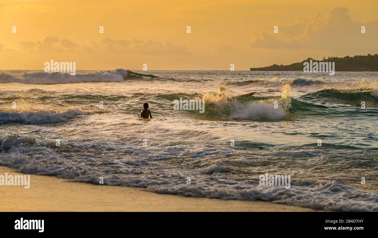 Local Kids surf on Waves in Sunset light, Beautiful Crystal Bay, Nusa ...