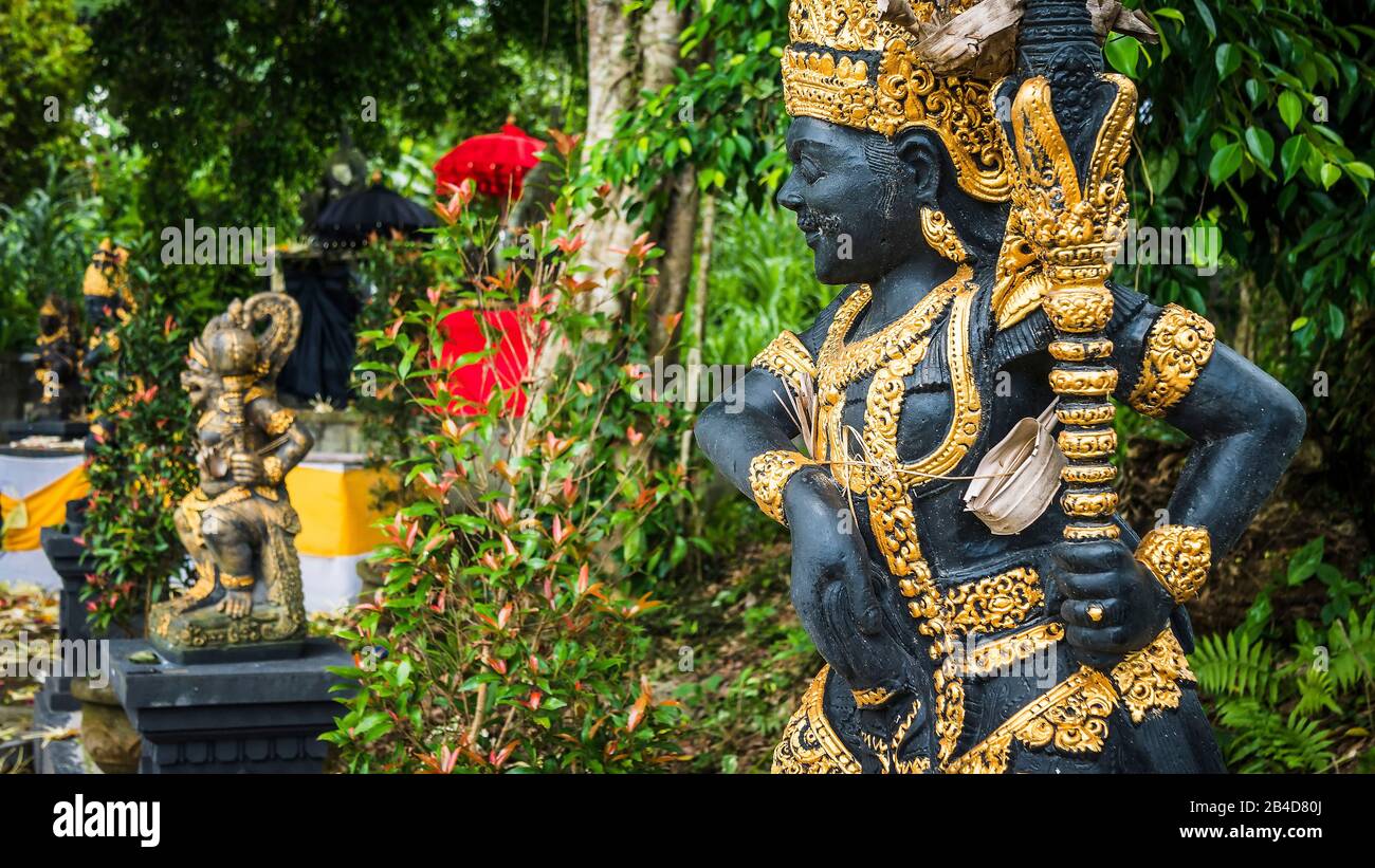 Bali temple entrance with black golden guardian statue Stock Photo - Alamy