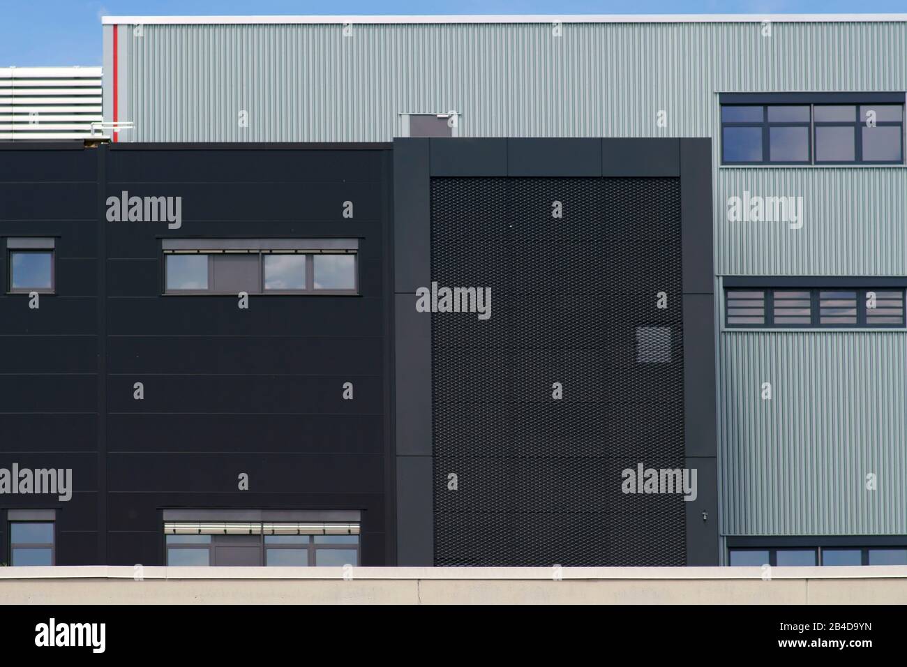 A modern industrial building with various sheet metal facades and ...