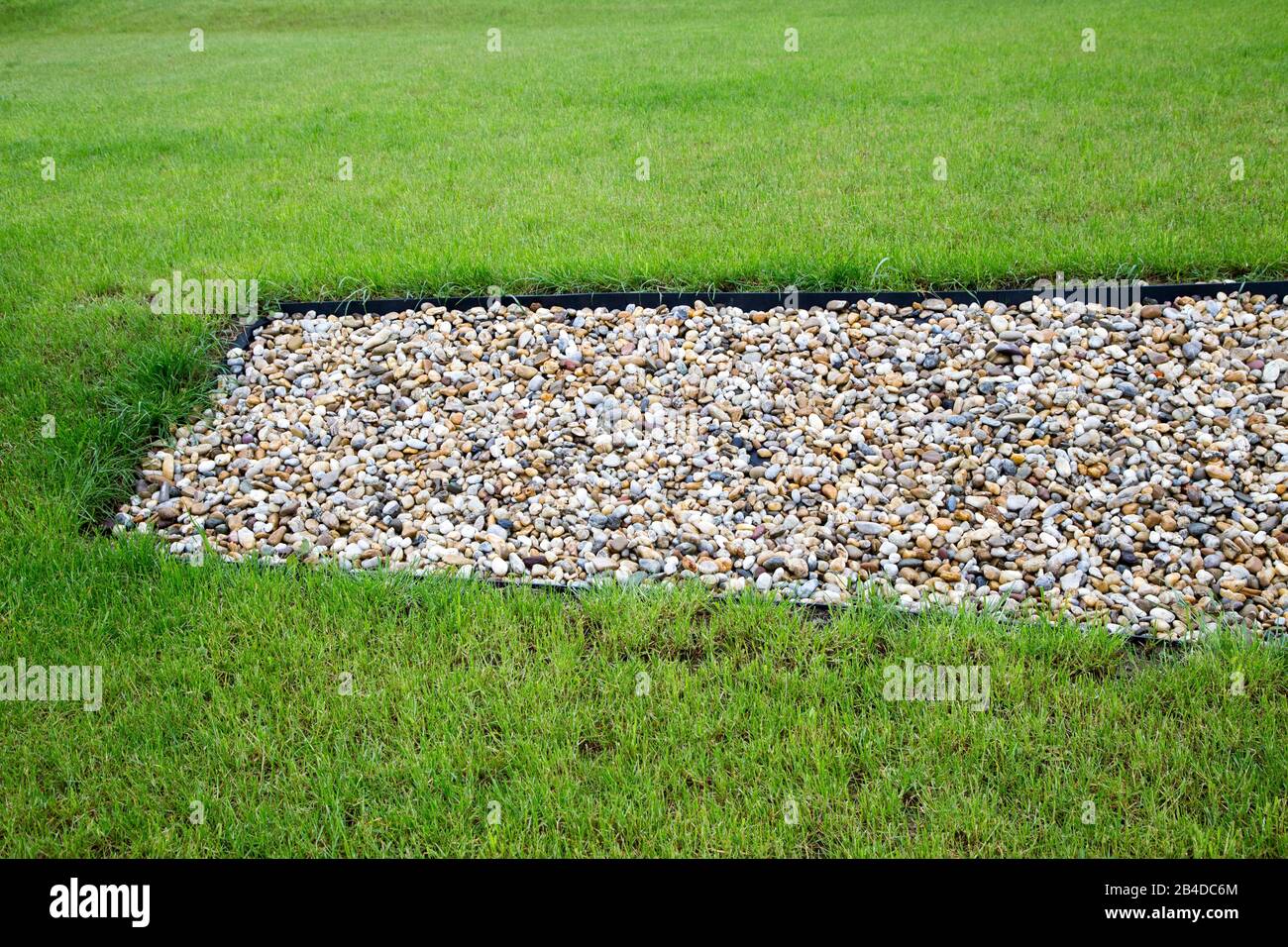 pebblestones and green grass Stock Photo - Alamy