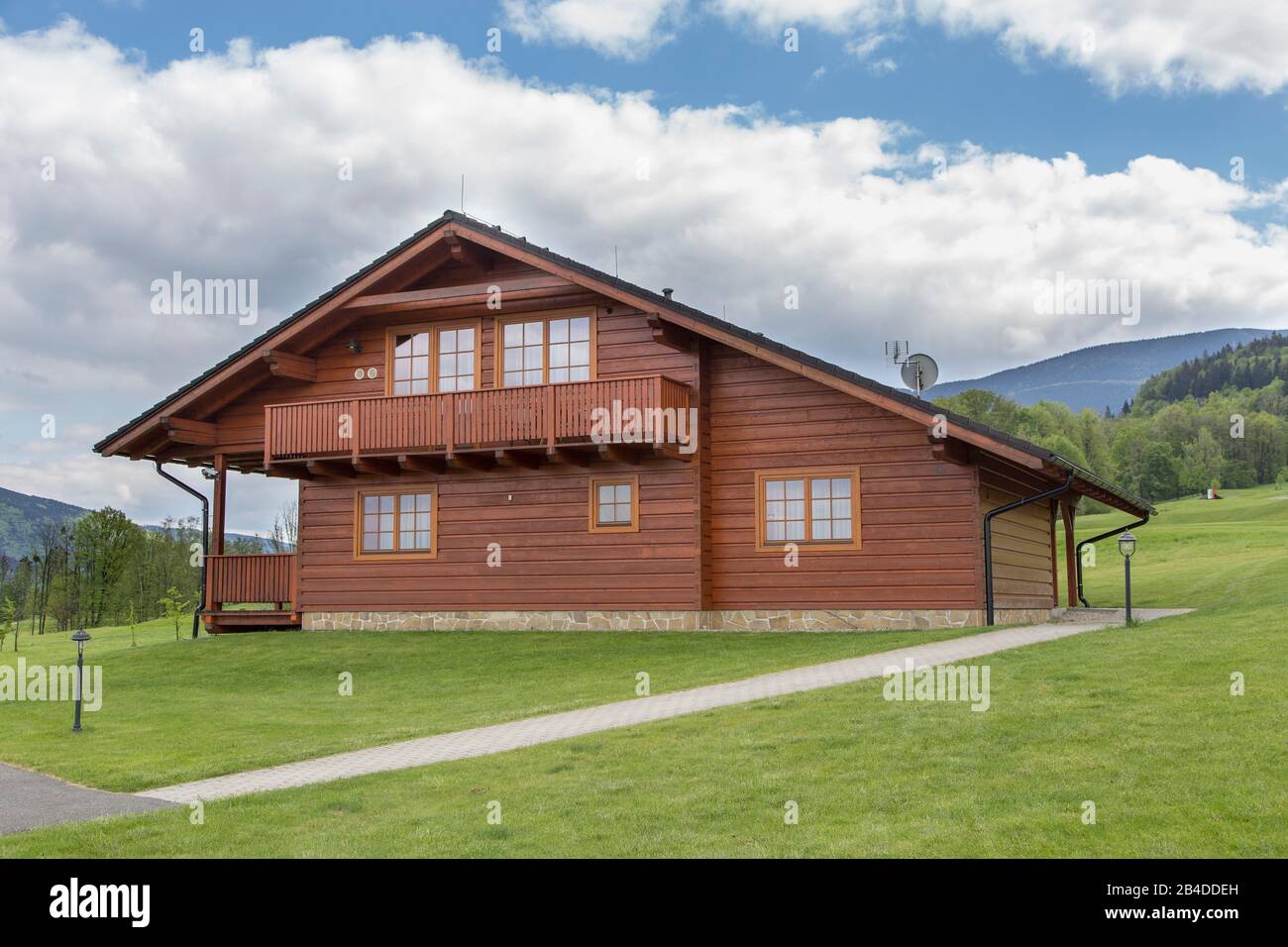 nice wooden house with lawn around Stock Photo - Alamy