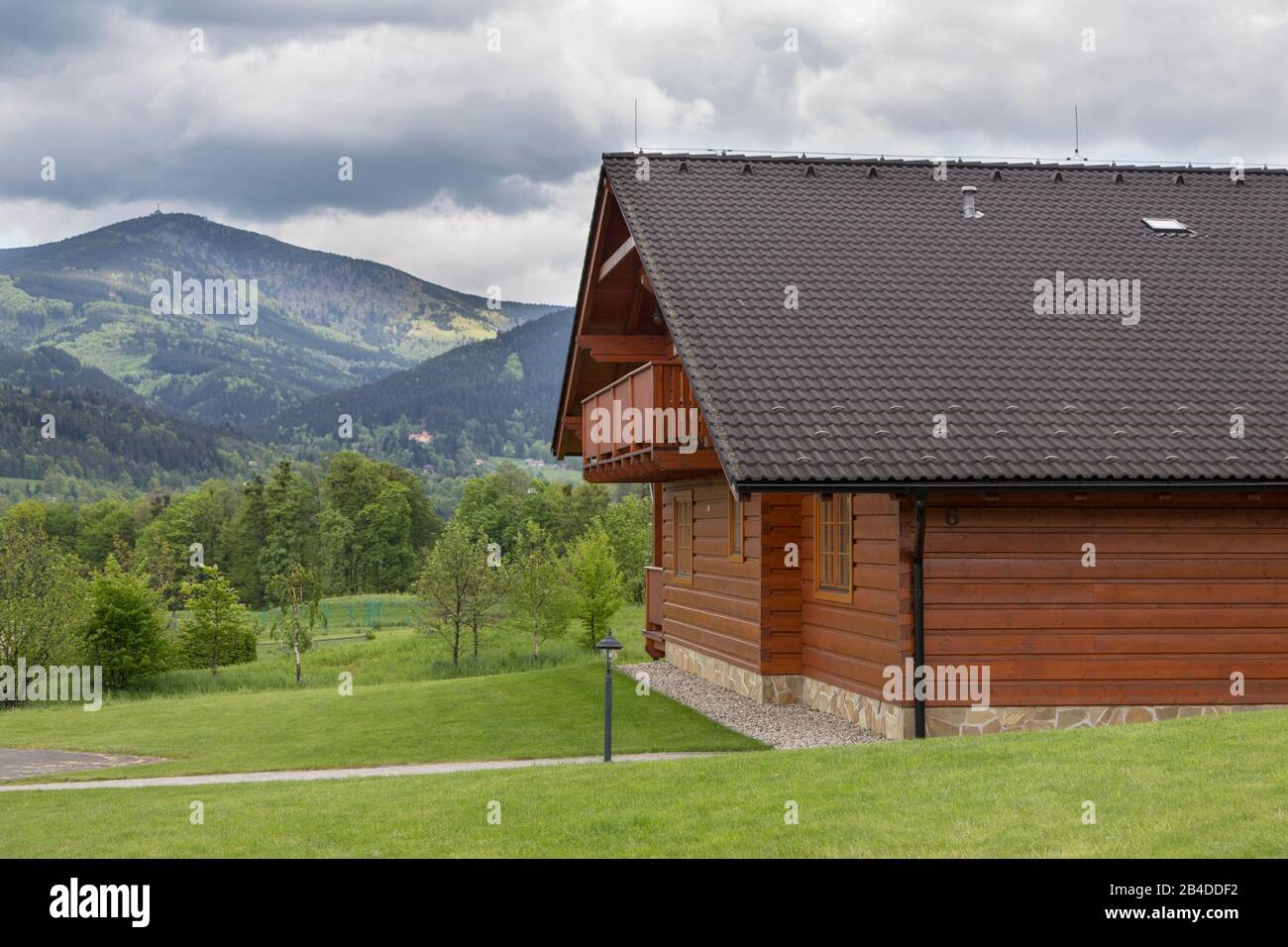 nice wooden house with lawn around Stock Photo - Alamy