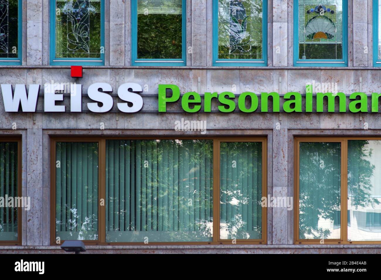 The logo of the Weiss Personalmanagement group at an office building in ...