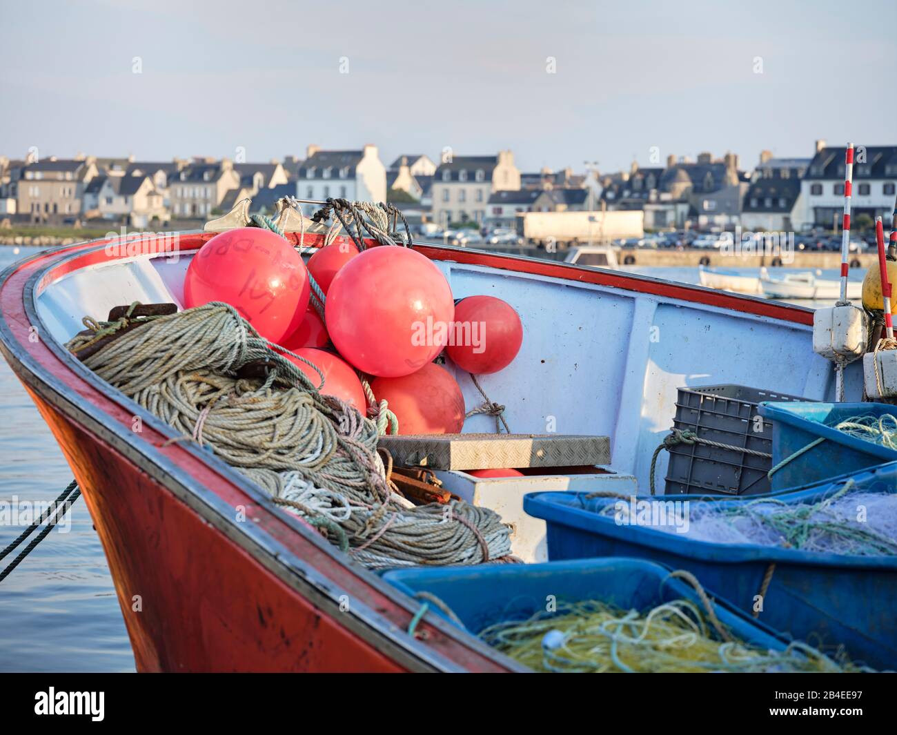 Red luminous buoys in a fishing boat in the harbor of Roscoff in ...