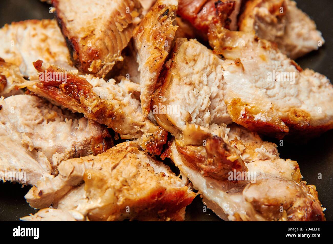 baked meat cut into pieces close up photo Stock Photo - Alamy