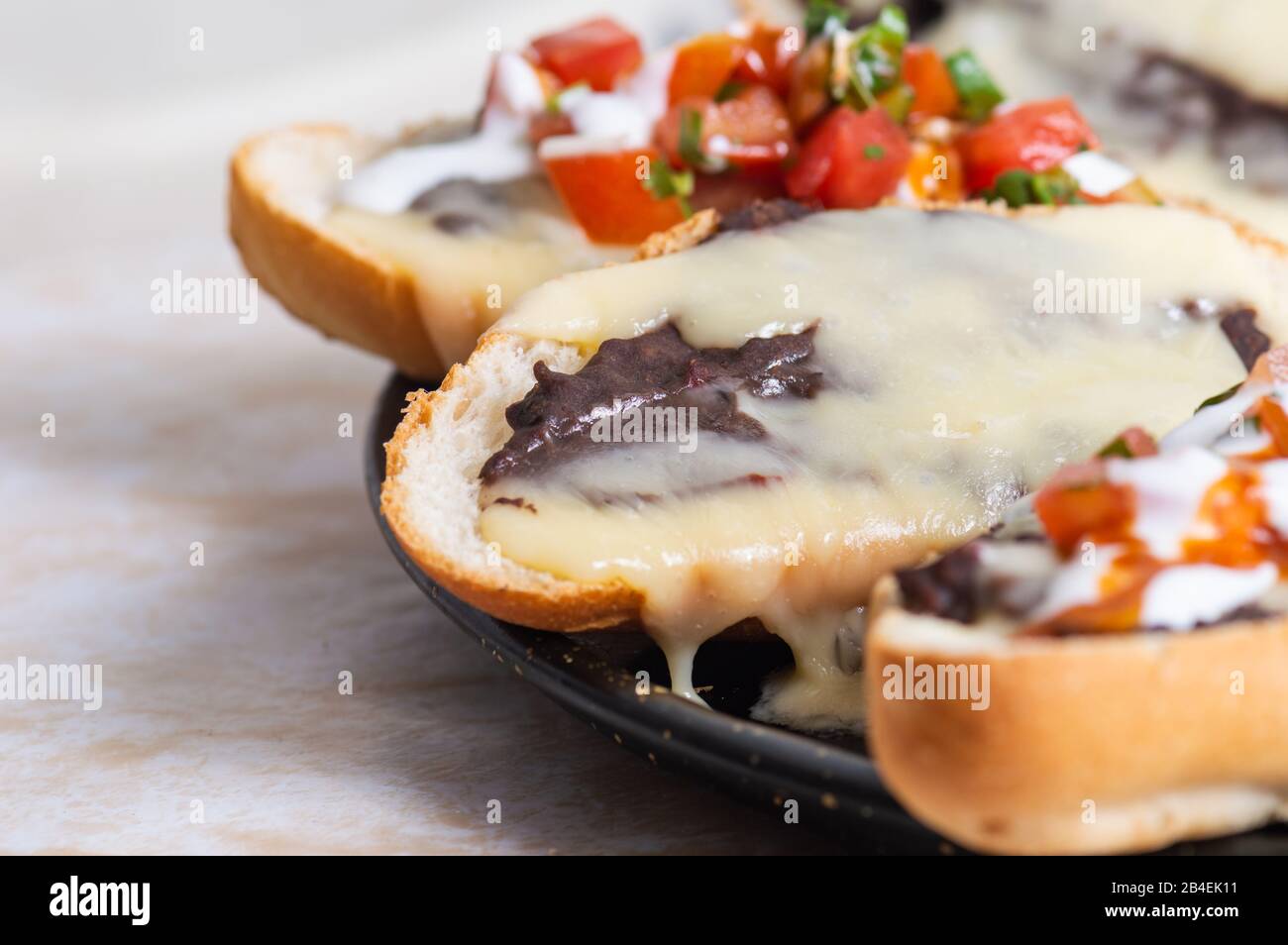 Molletes. Vegetarian Mexican food similar to bruschetta. Refried beans ...