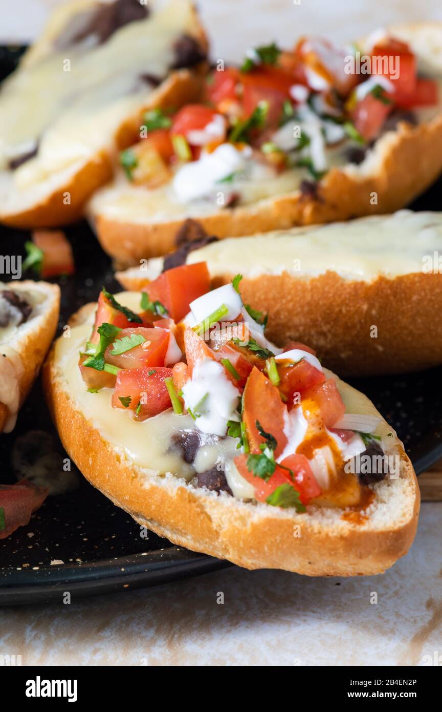 Molletes. Vegetarian Mexican food similar to bruschetta. Refried beans ...