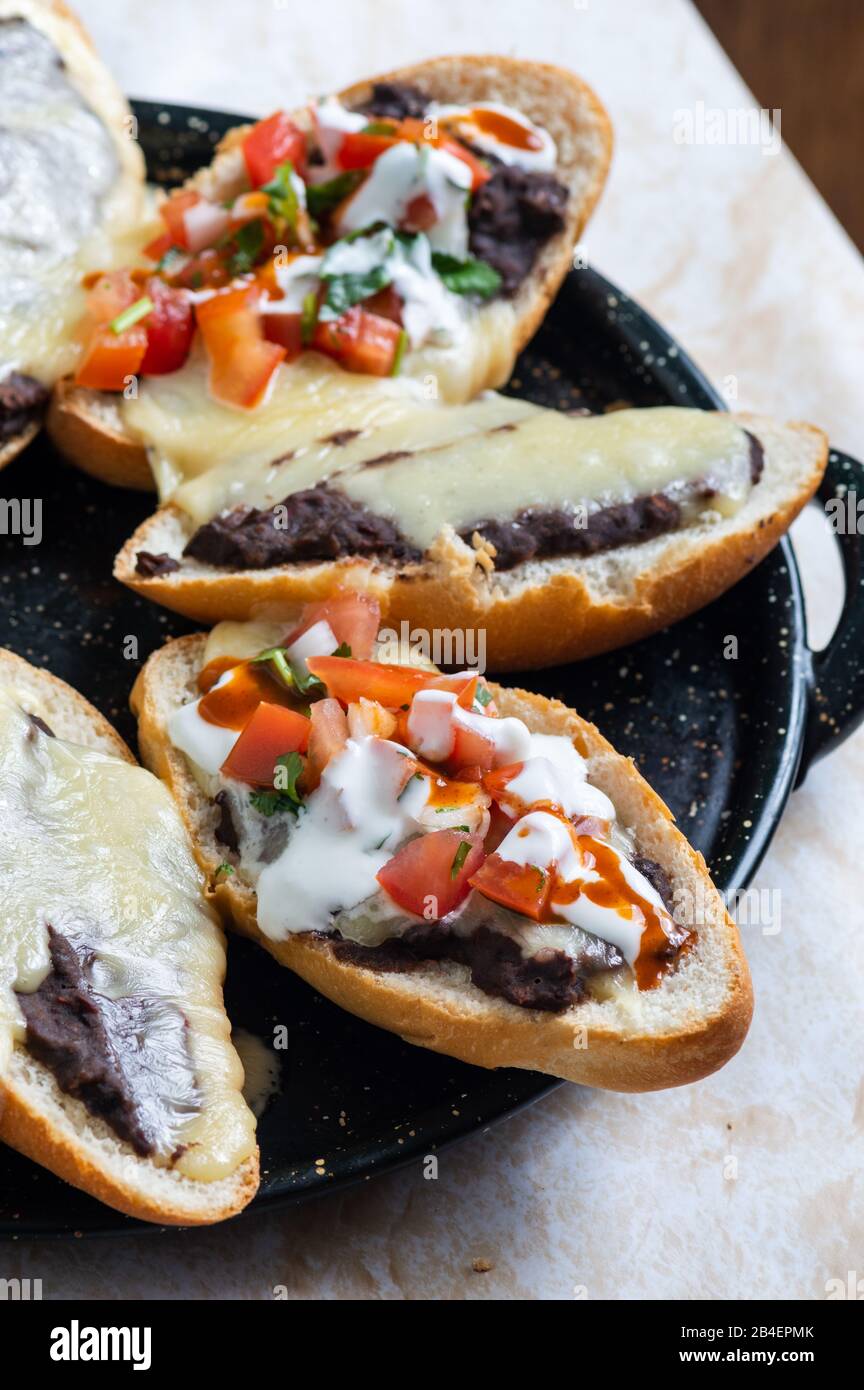 Molletes. Vegetarian Mexican food similar to bruschetta. Refried beans ...