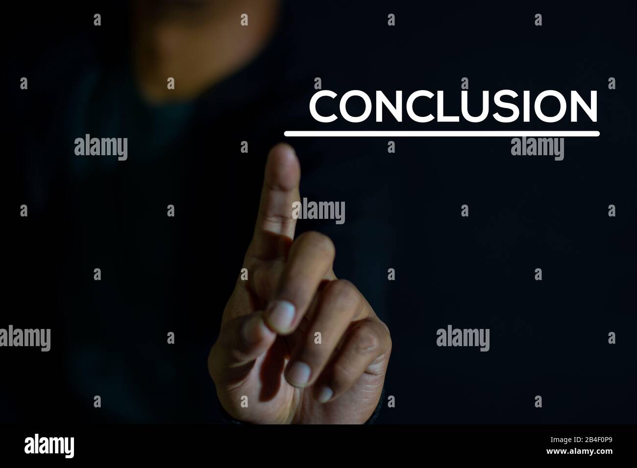 A man write a conclusion with a black background Stock Photo - Alamy
