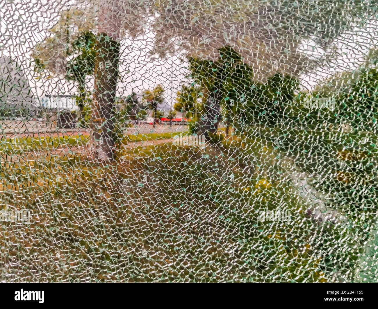 glass window completely cracked, scenery shining through, Shattered ...