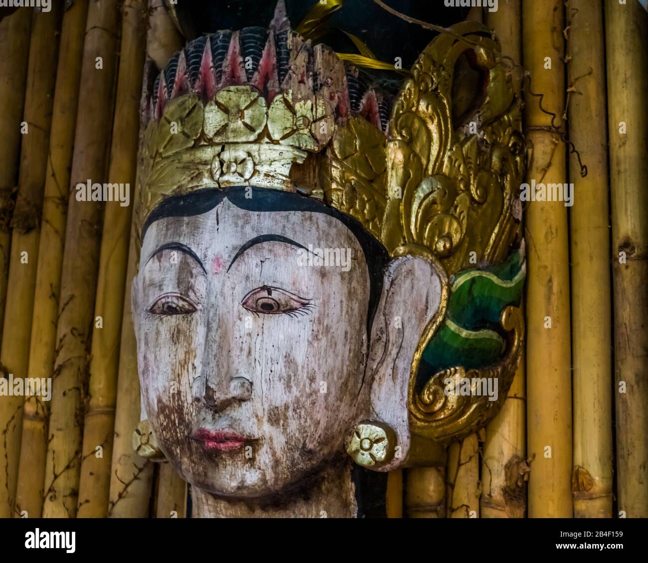 the face of a traditional asian wooden sculpture, Spiritual statue ...
