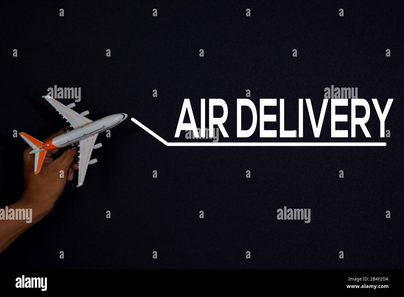 Airplane on hand and Air Delivery write on dark black background. cargo ...