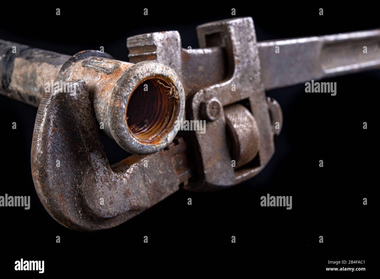 Old dirty pipe and hydraulic wrench. Accessories and tools for a ...