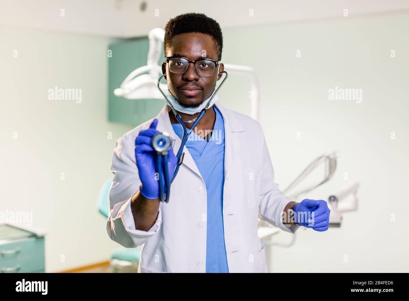 Close-up of male African American doctor hand stethoscope head ready to ...