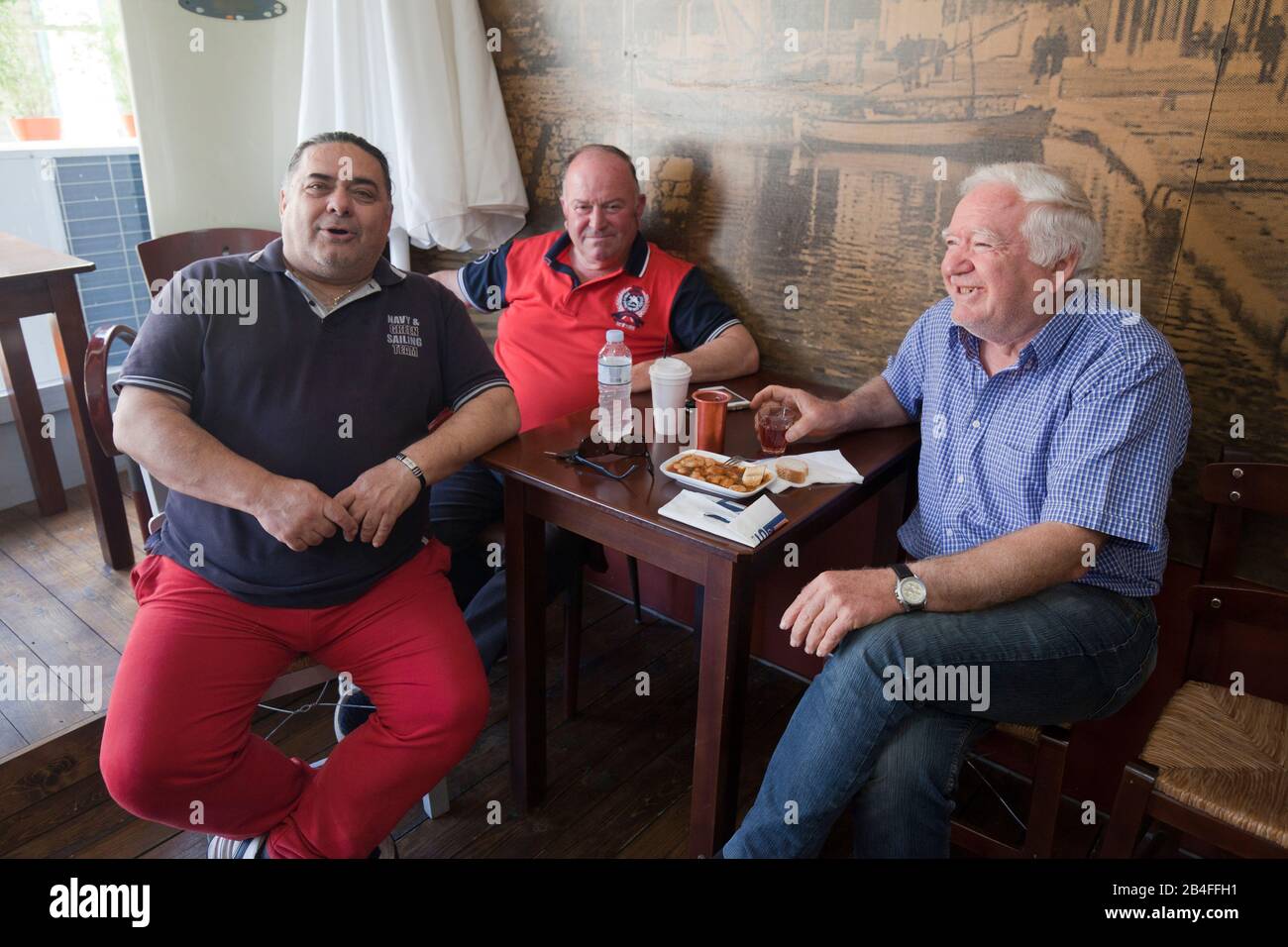 Native elderly greeks in a tavern in astakos hi-res stock photography ...