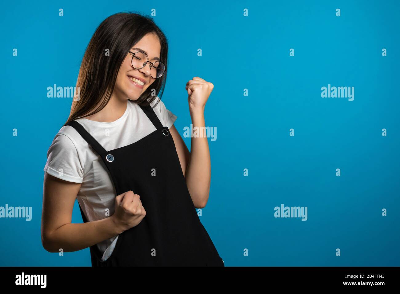 Asian girl with long hair very glad and happy, she shows yes gesture of ...