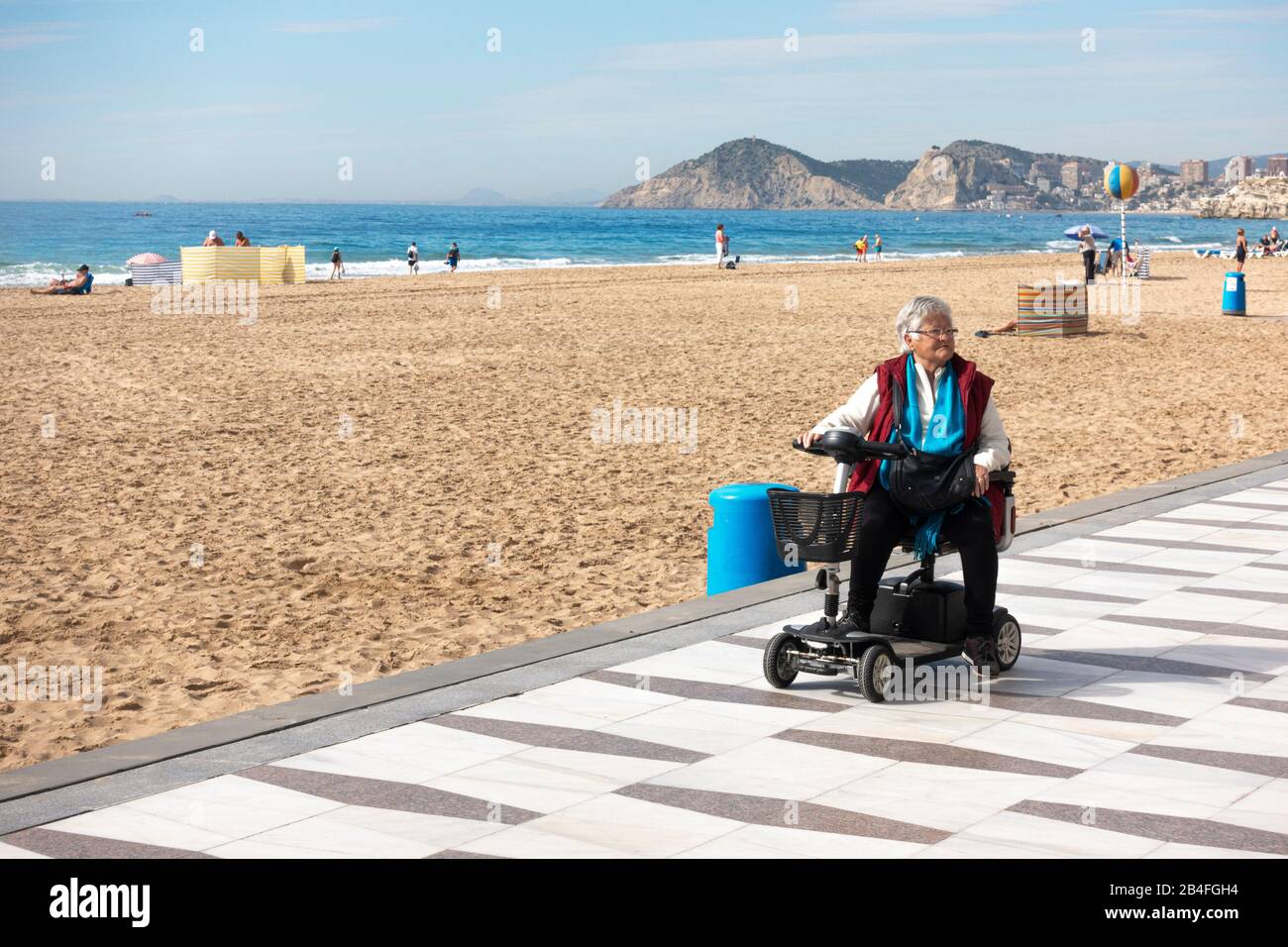 Woman with mobility scooter in Levante beach area in Benidorm, Spain ...