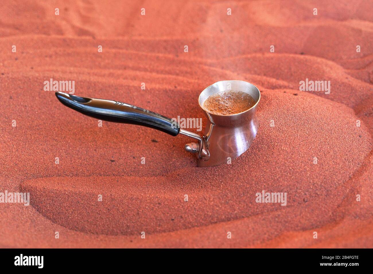 Coffee prepared on street in traditional Arabic way, cezve or ibrik ...