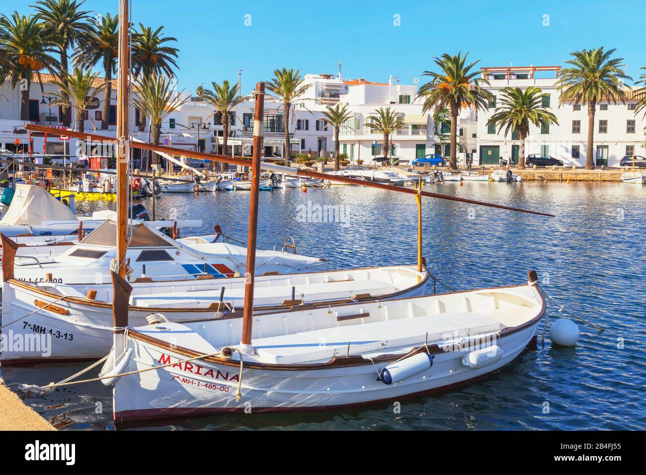 Boats moored in the harbour of the fishing village of Fornells. Menorca ...