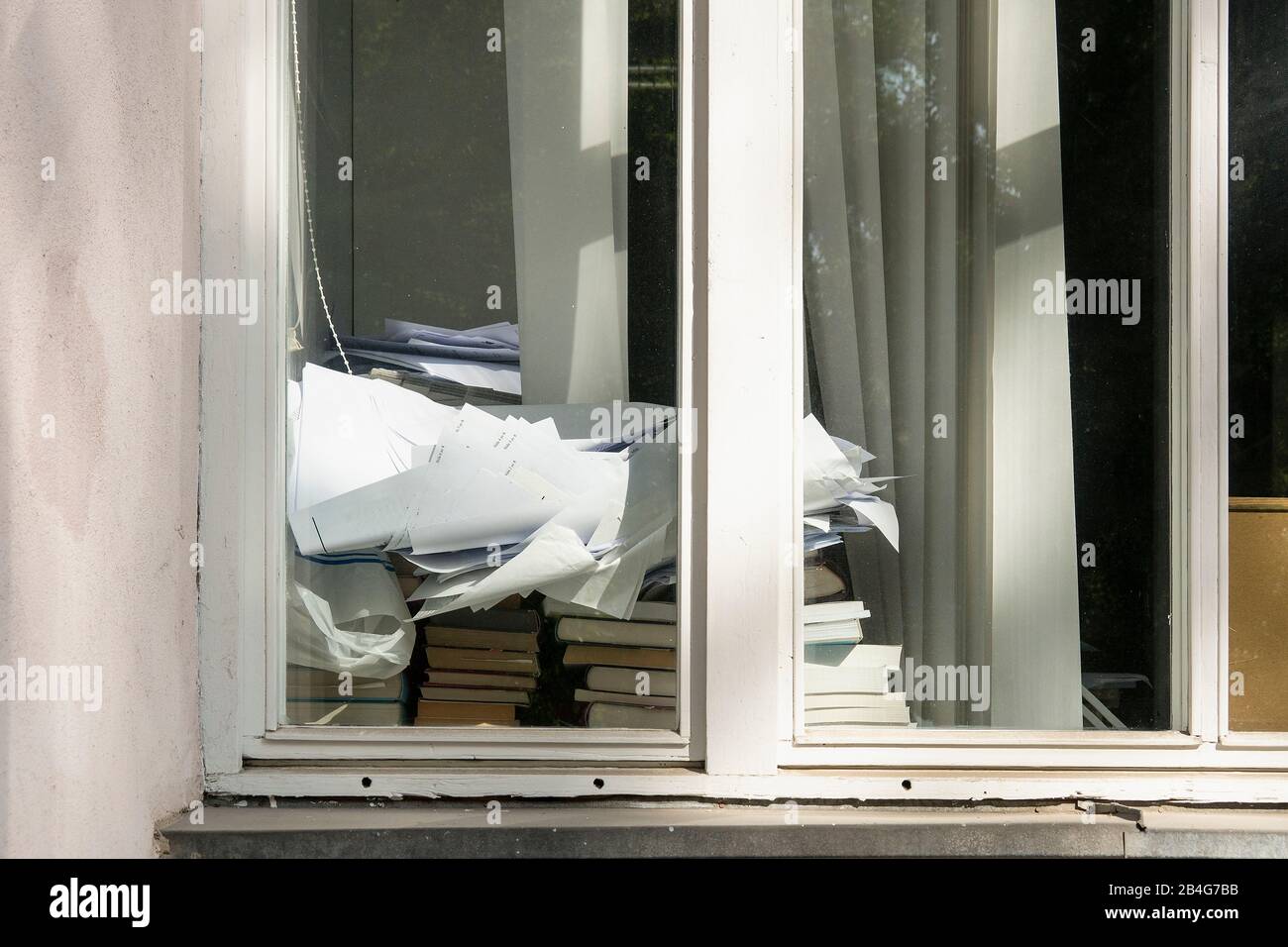 Estonia, Tartu, windows, piles of books and papers, clutter Stock Photo ...