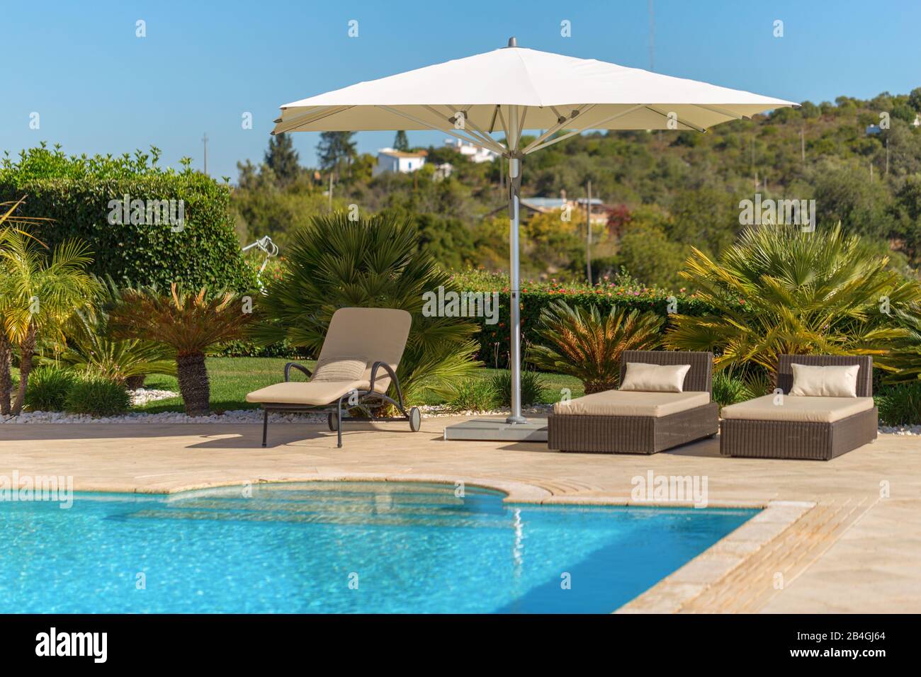 Sun bath with sun loungers and parasol. In Portugal Stock Photo - Alamy