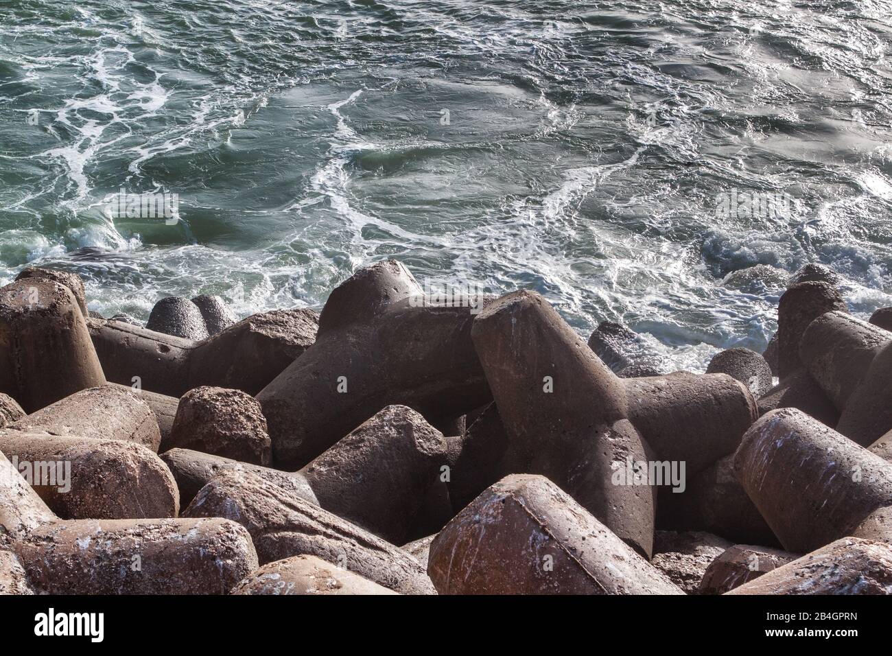 Stones are concrete constructions of the quay of breakers of ...