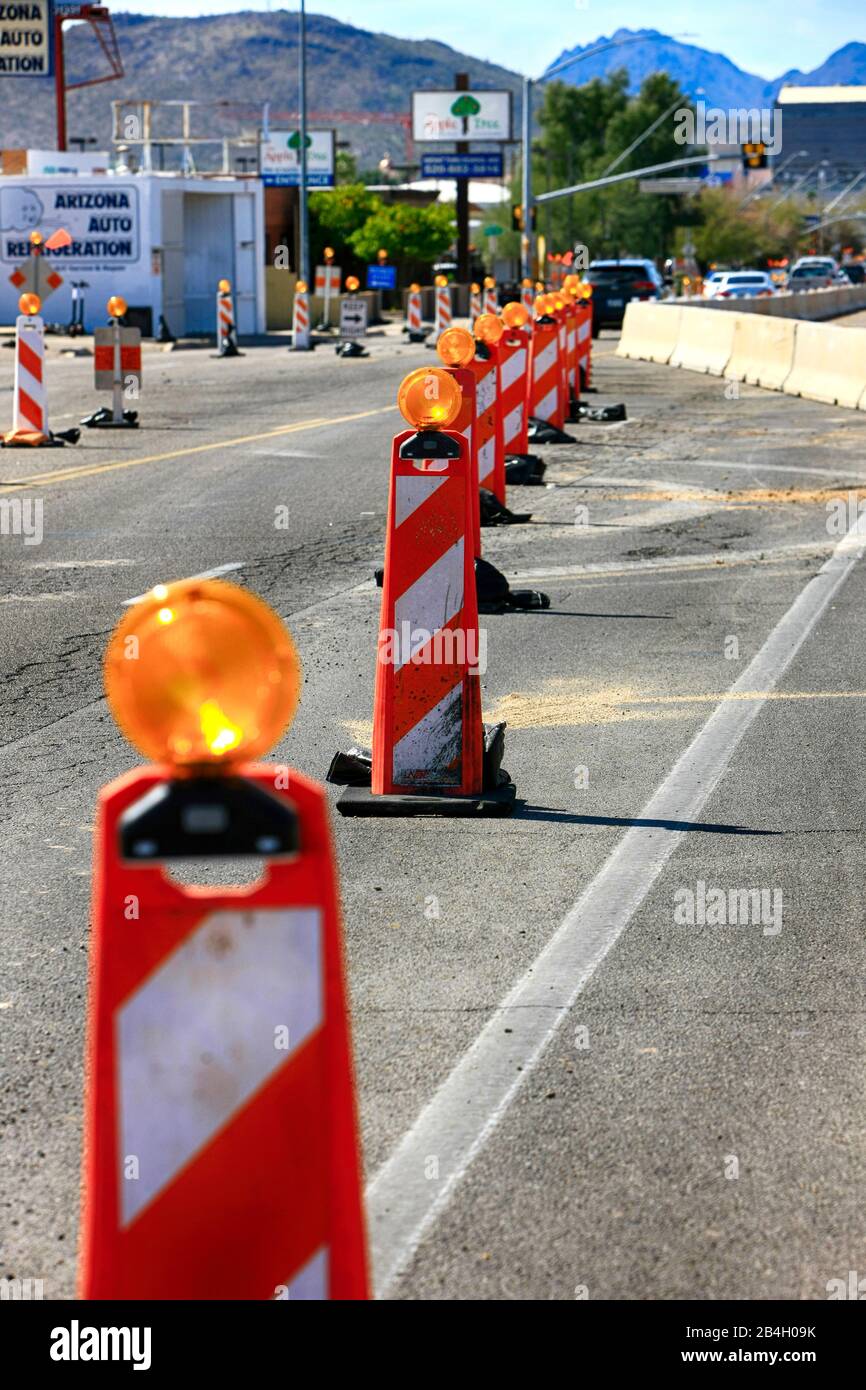 Road lane change markers with reflective tapeand an orange lantern in a ...