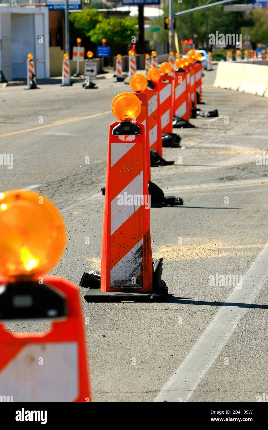 Road lane change markers with reflective tapeand an orange lantern in a ...