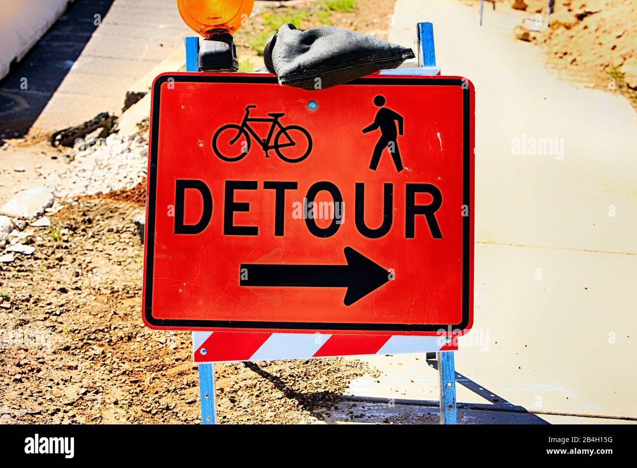 Hot-orange colored Detour sign for pedestrians and cyclists at the ...