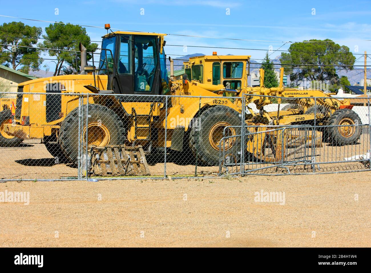 Multiple heavy machinery vehicles in a compound of a road construction ...
