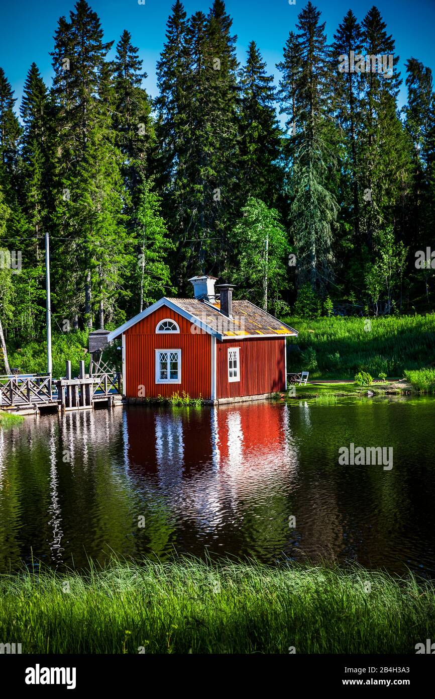 Red house by the water in Sweden Stock Photo - Alamy