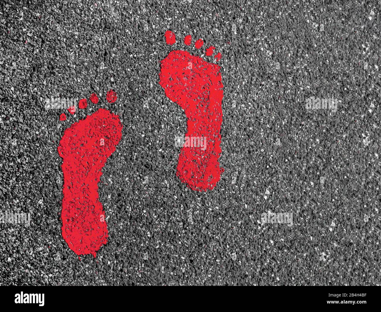 Red footprint signs on an asphalt road for pedestrian. Symbol of ...
