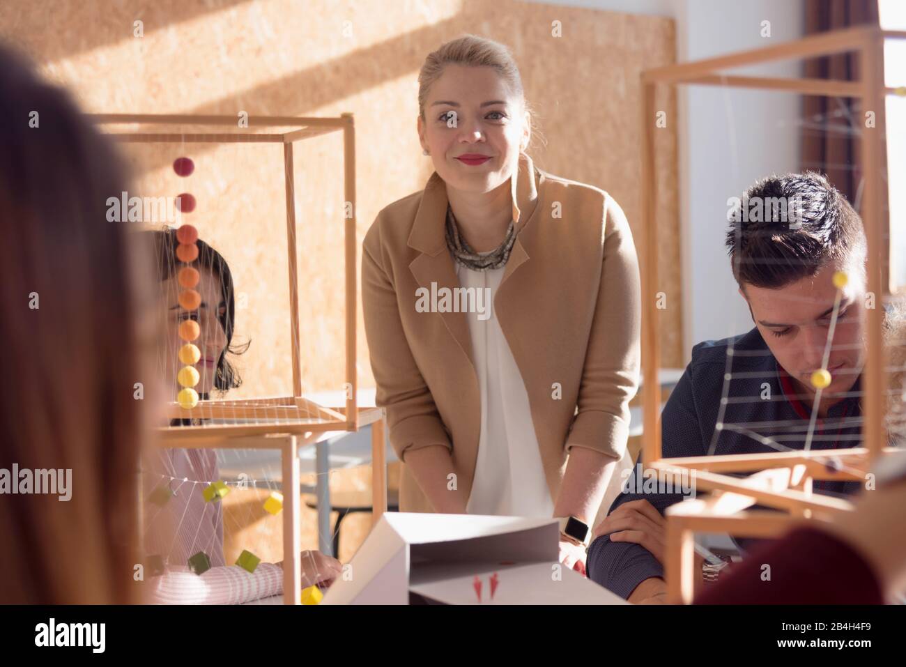 Female Architecture teacher at work. Female professor explain ...